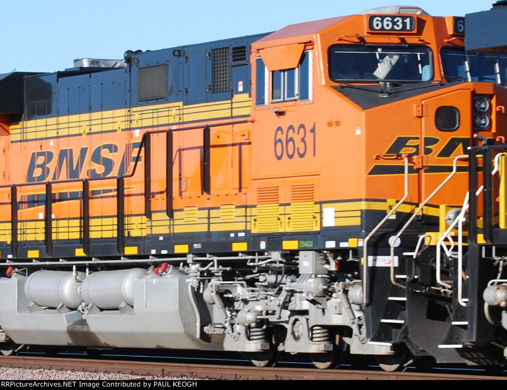 A still Very Clean and Brand New ES44C4 (BNSF 6631) rolls eastbound behind BNSF 7877 pulling a ...